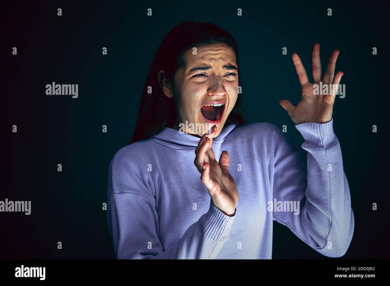 Trying to hide. Portrait of young crazy scared and shocked caucasian ...