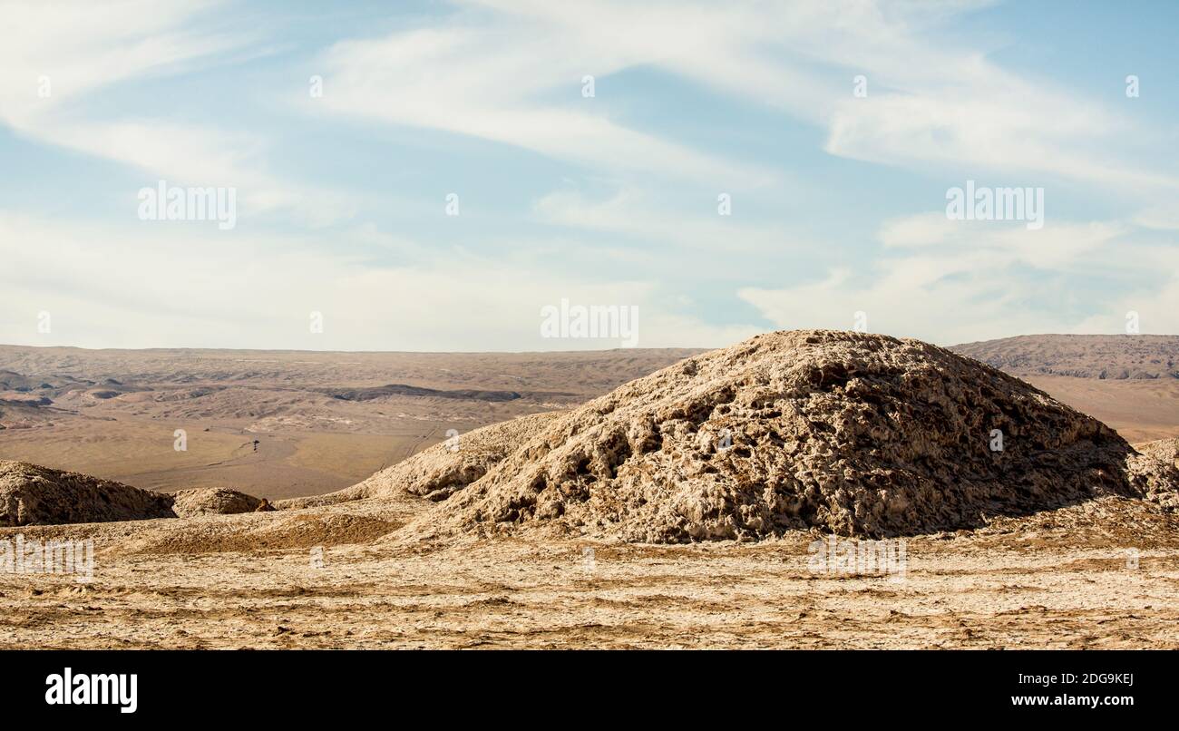 Eroded orange rocks and desert cliffs showing rock strata, in the Valle ...