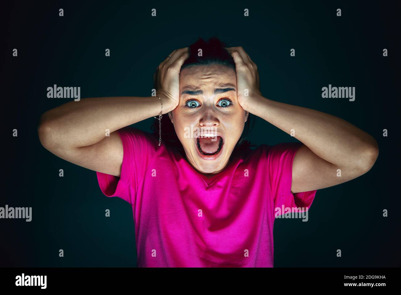 Holding head. Portrait of young crazy scared and shocked caucasian ...