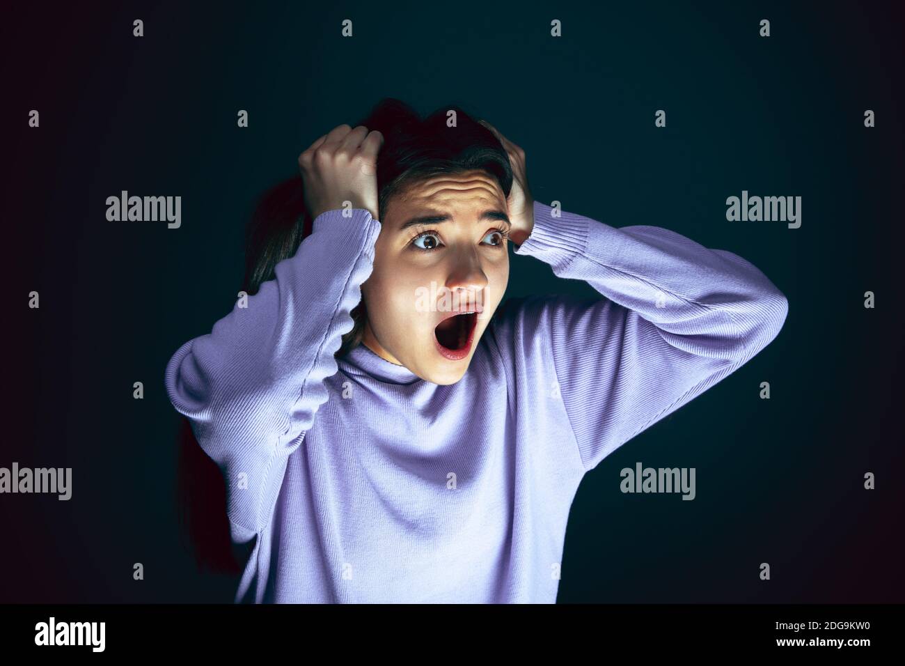 Holding head. Portrait of young crazy scared and shocked caucasian ...