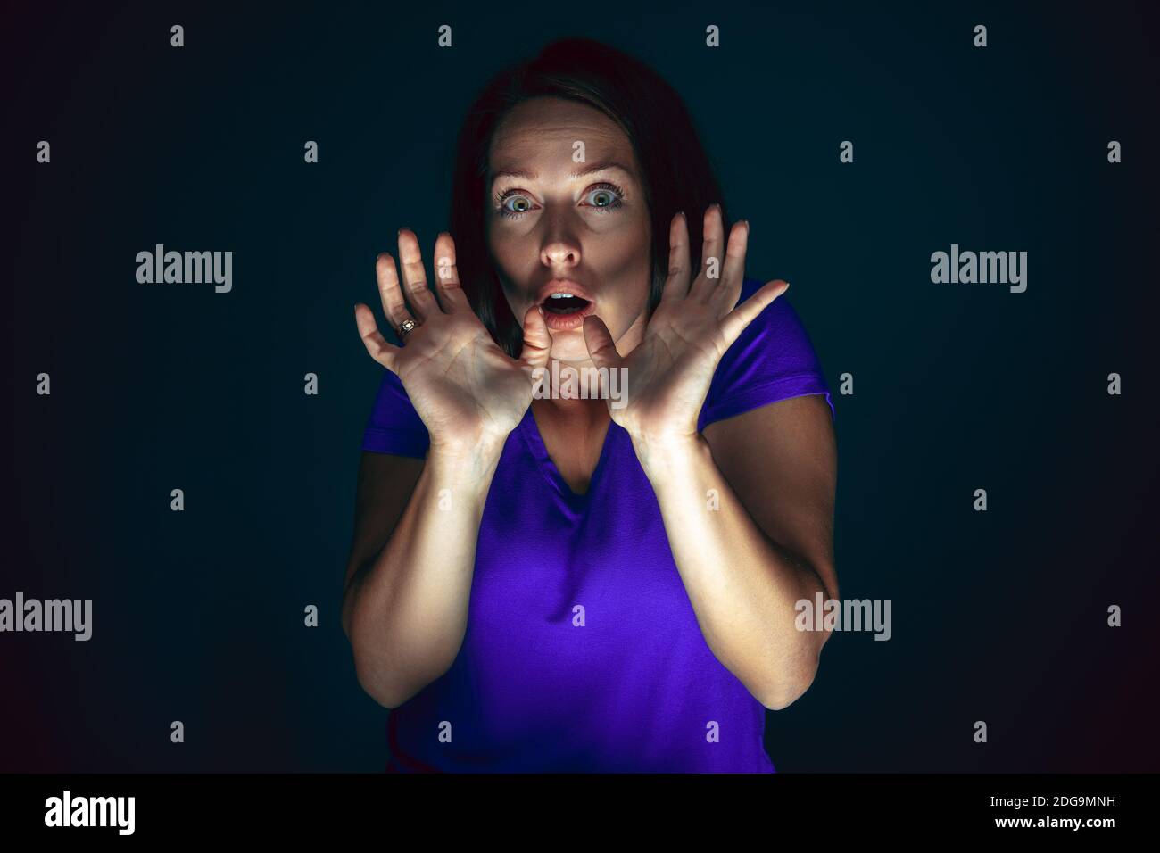 Hiding. Portrait of young crazy scared and shocked caucasian woman ...