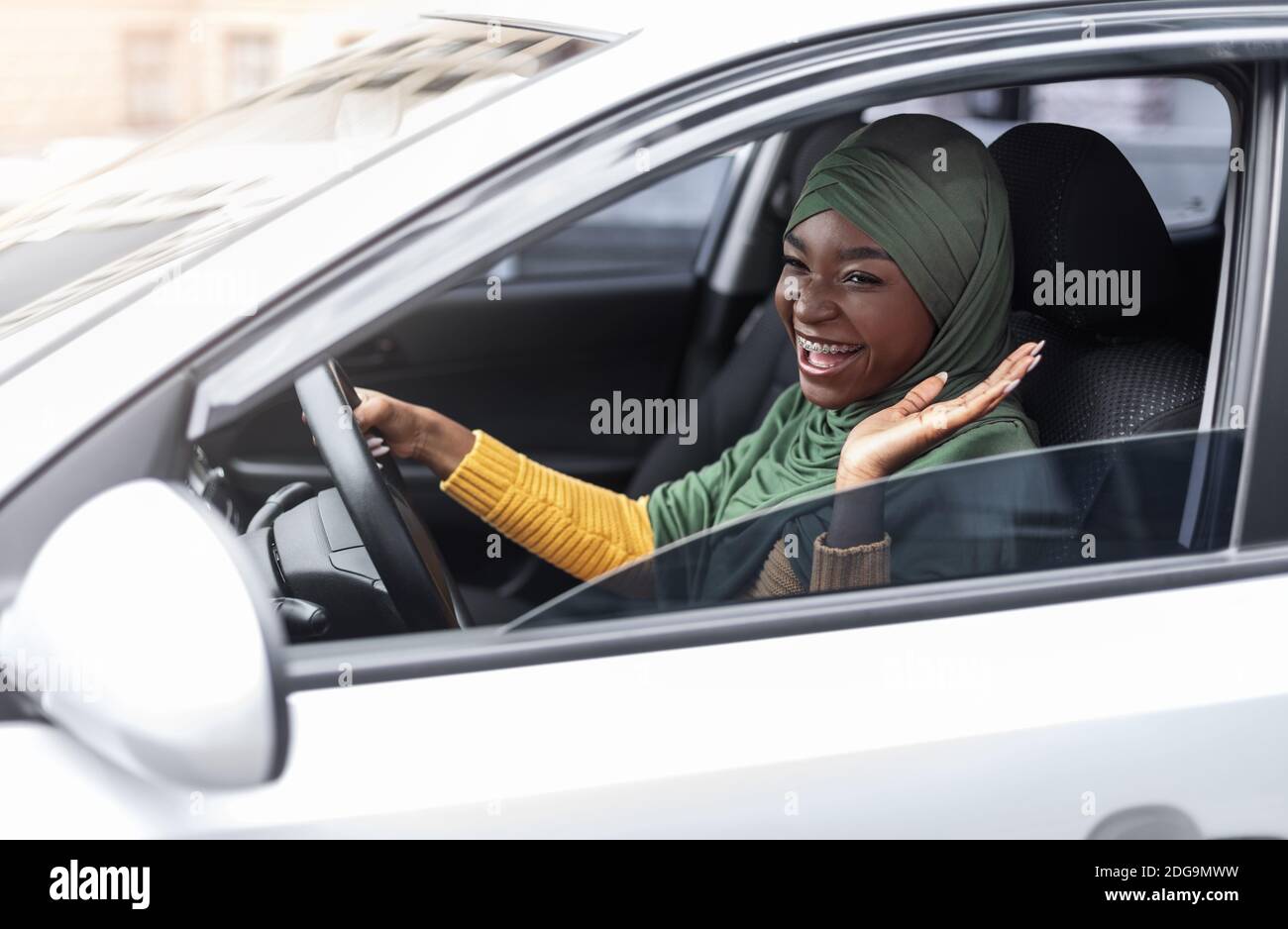 Happy Car Owner. Cheerful Black Muslim Lady In Hijab Driving New ...