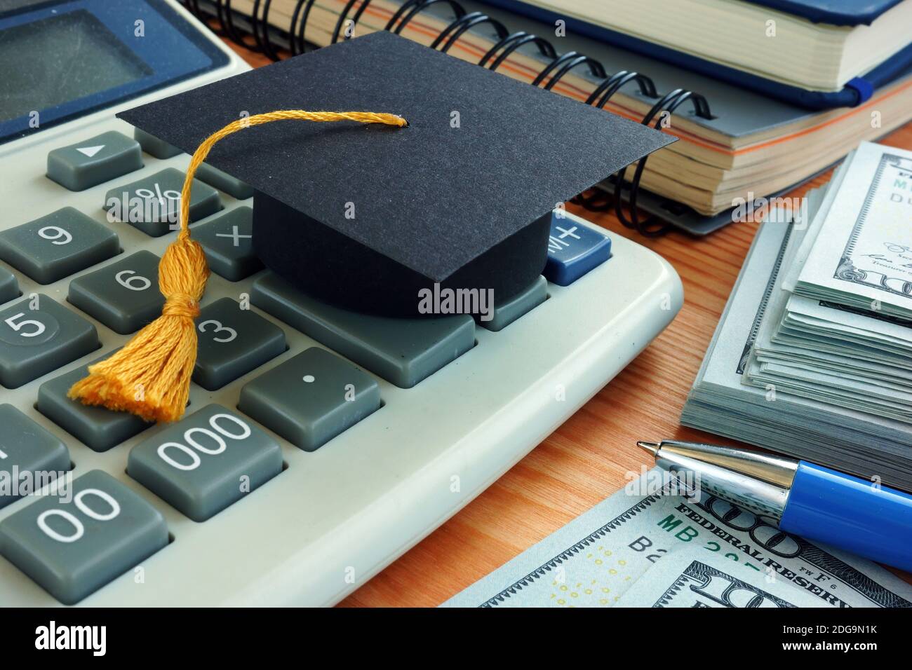 Student loan concept. Graduation cap on the calculator Stock Photo - Alamy