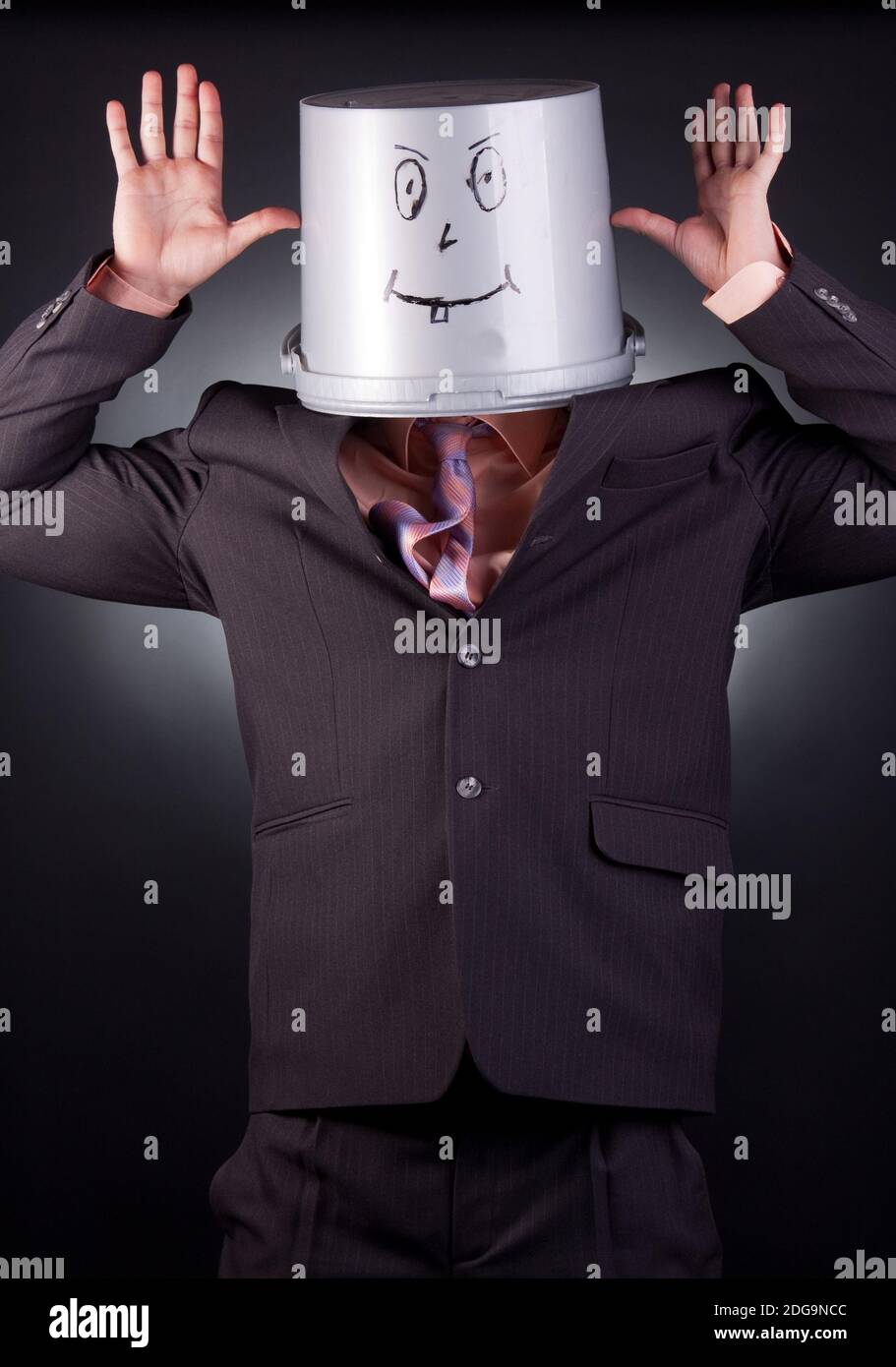 funny businessman with a bucket on his head Stock Photo - Alamy