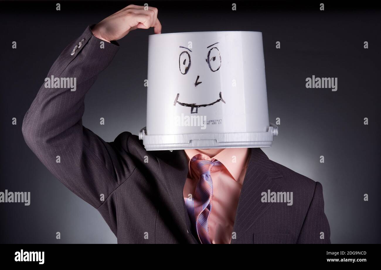 funny businessman with a bucket on his head Stock Photo - Alamy