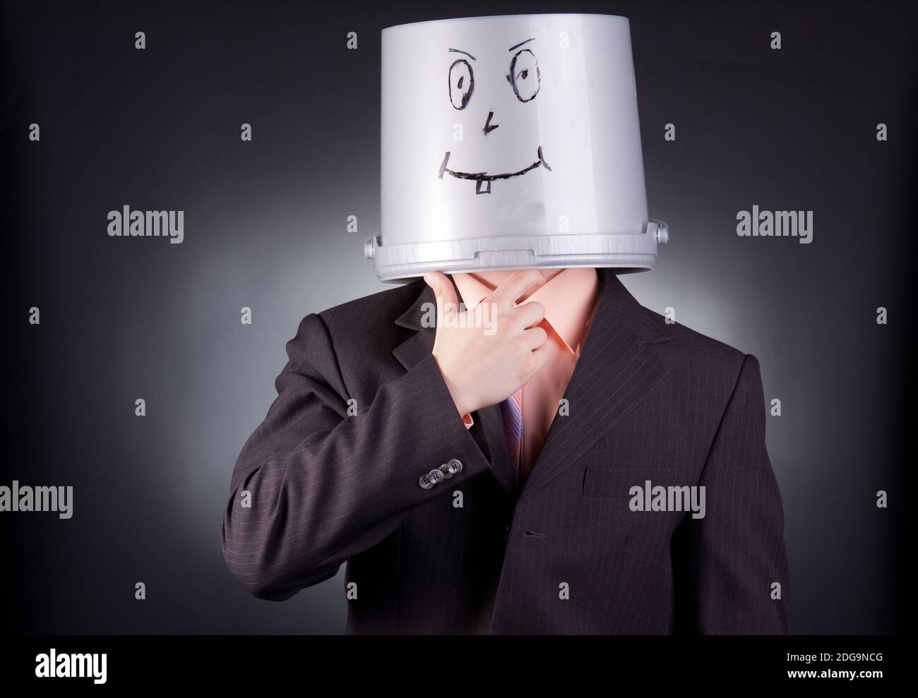 funny businessman with a bucket on his head Stock Photo - Alamy