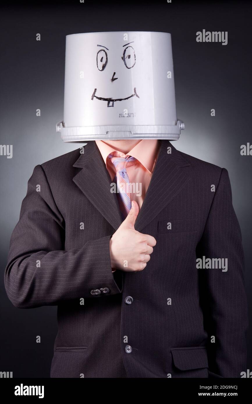 funny businessman with a bucket on his head Stock Photo - Alamy