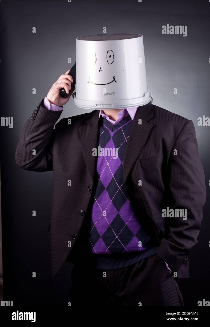 funny businessman with a bucket on his head Stock Photo - Alamy
