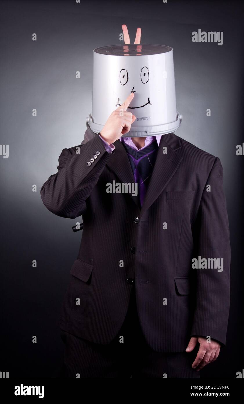 funny businessman with a bucket on his head Stock Photo - Alamy