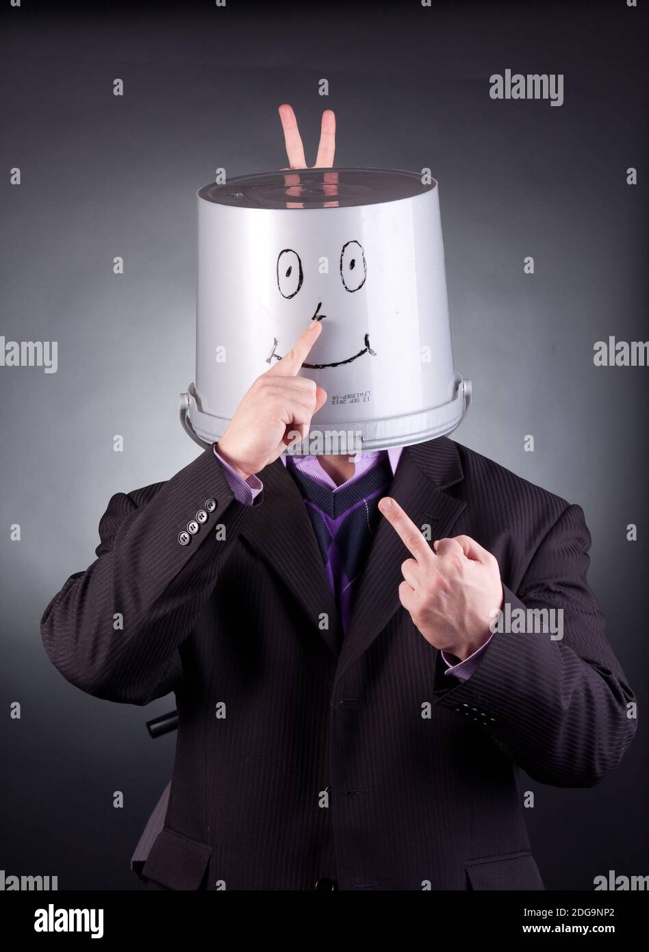 funny businessman with a bucket on his head Stock Photo - Alamy