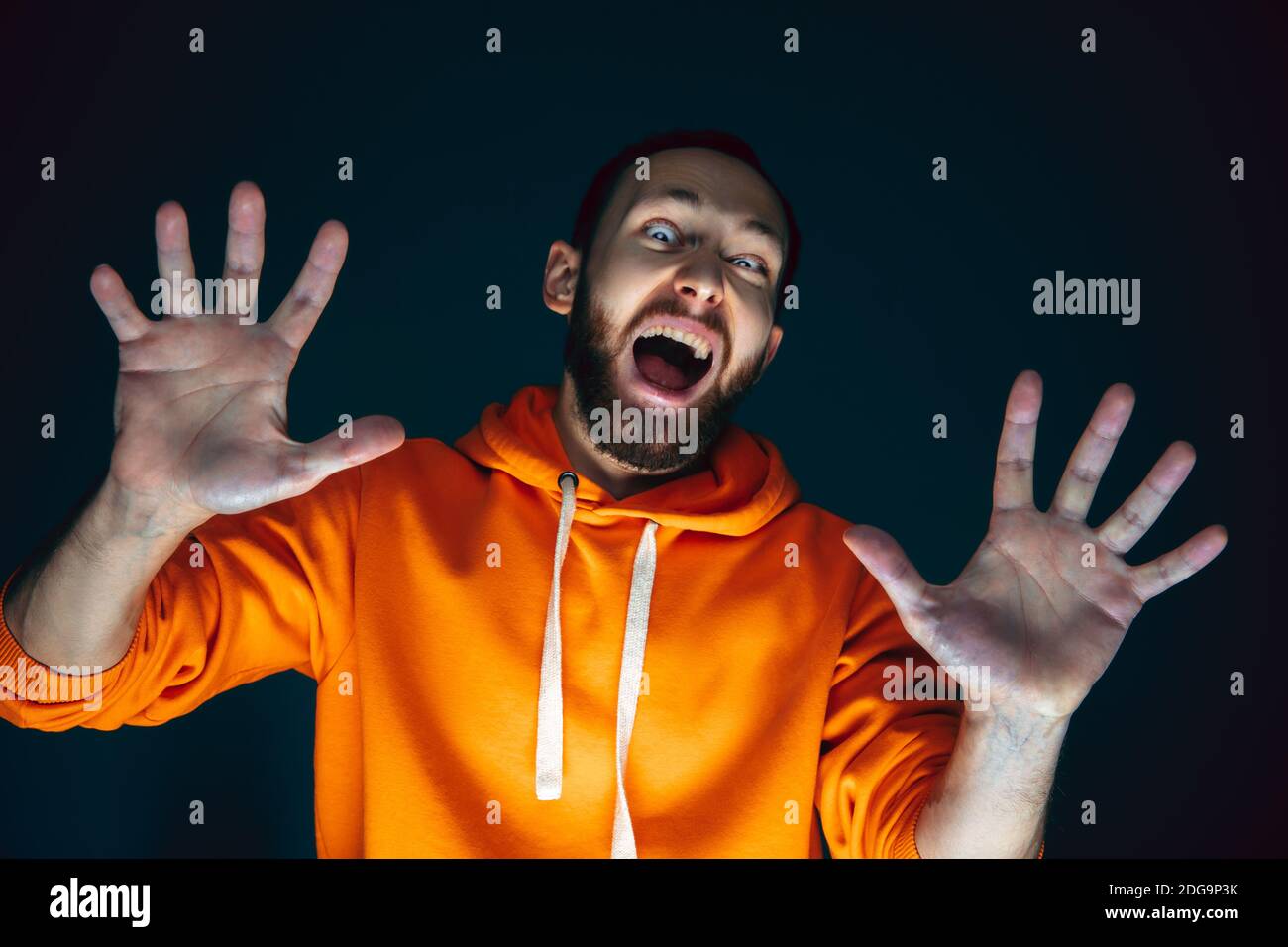 Defending. Portrait of crazy scared and shocked caucasian man isolated ...