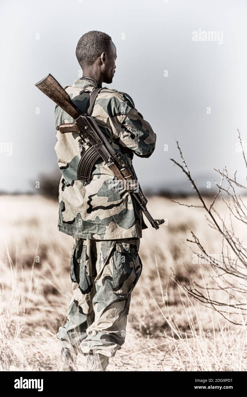 A black soldier and his gun looking the boarder Stock Photo - Alamy