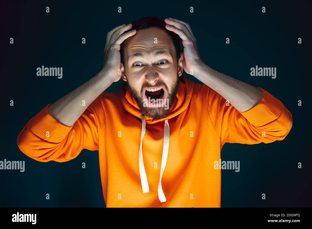 Holding head. Portrait of crazy scared and shocked caucasian man ...