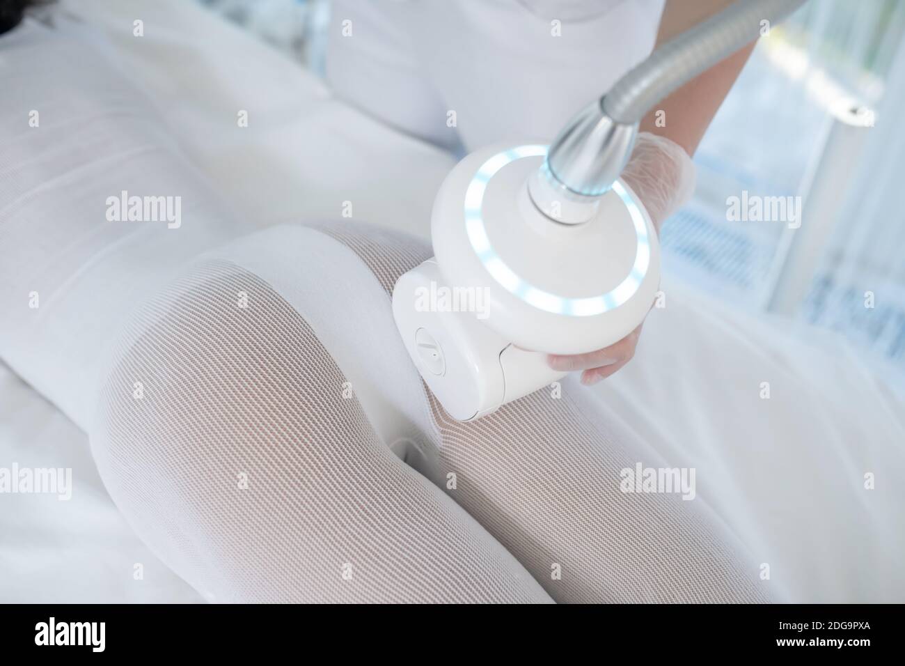 Doctors hand with working apparatus for body correction Stock Photo - Alamy
