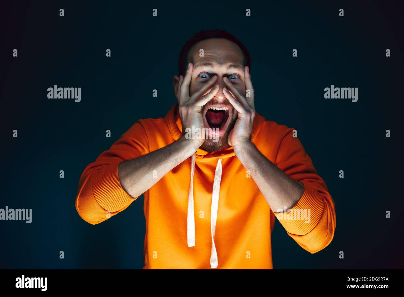 Hiding face. Portrait of crazy scared and shocked caucasian man ...