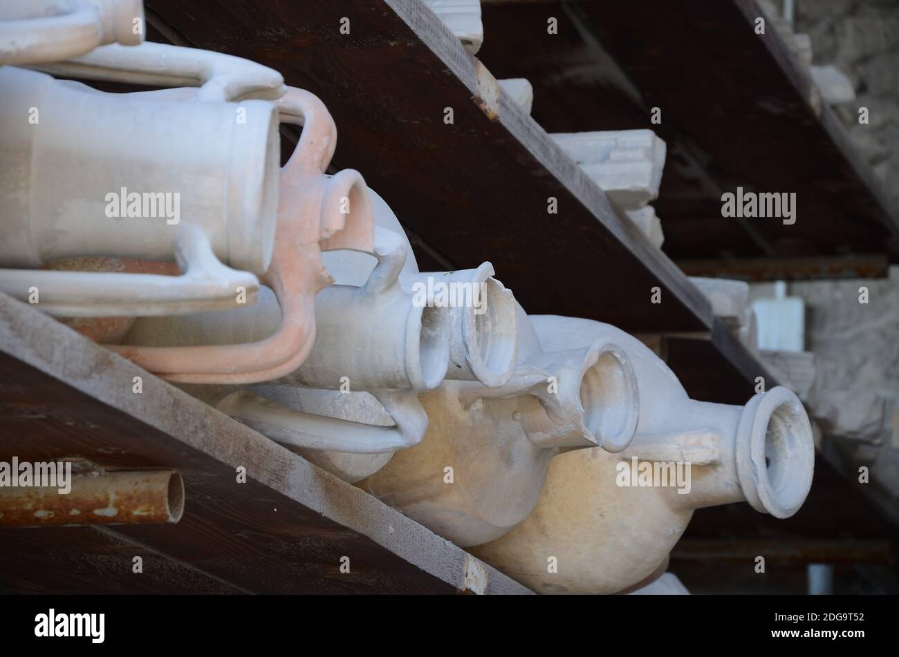 A closeup shot of clay pitchers of different sizes in a shelf Stock ...