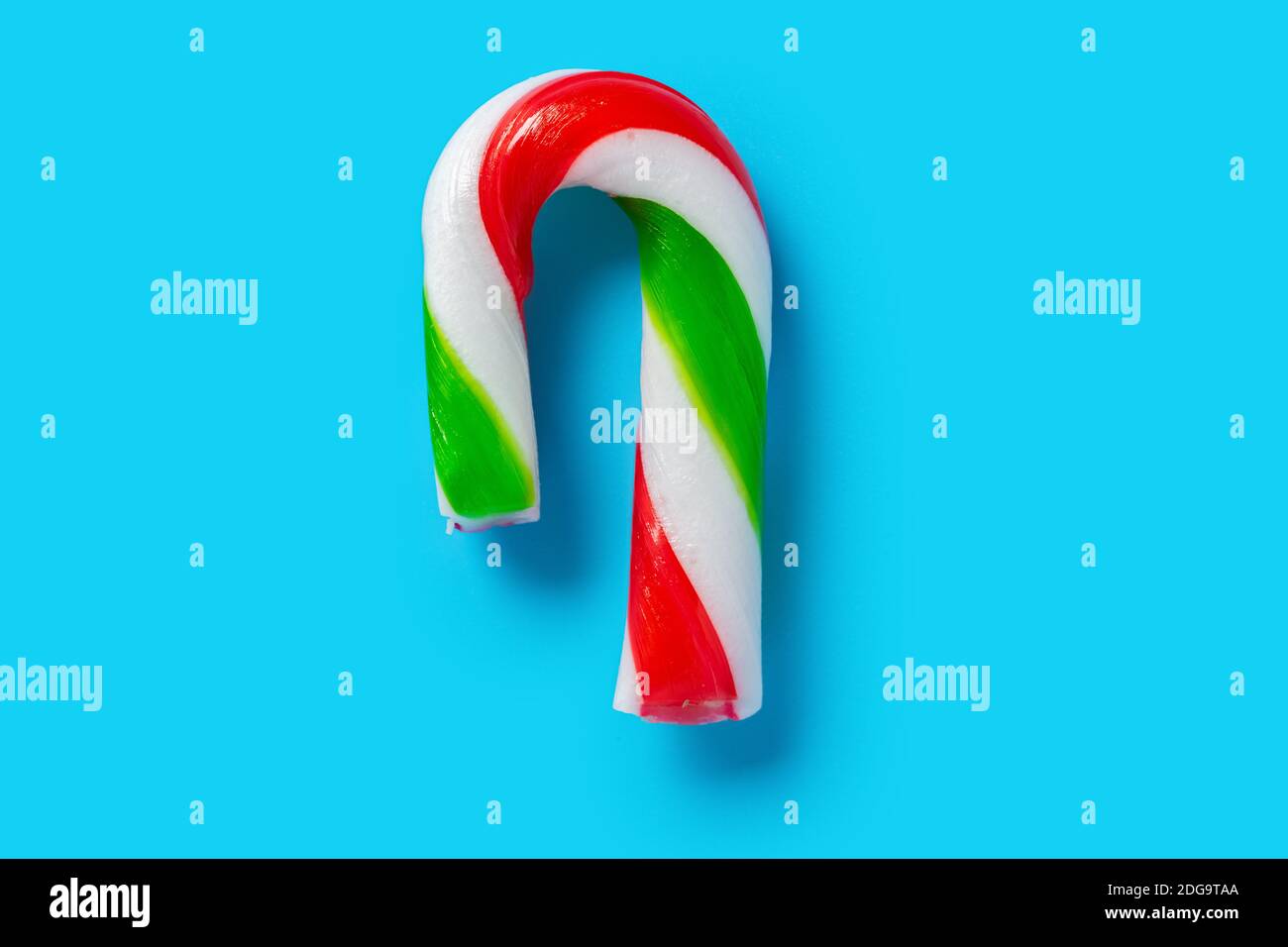 Christmas stick candy on a blue background Stock Photo - Alamy