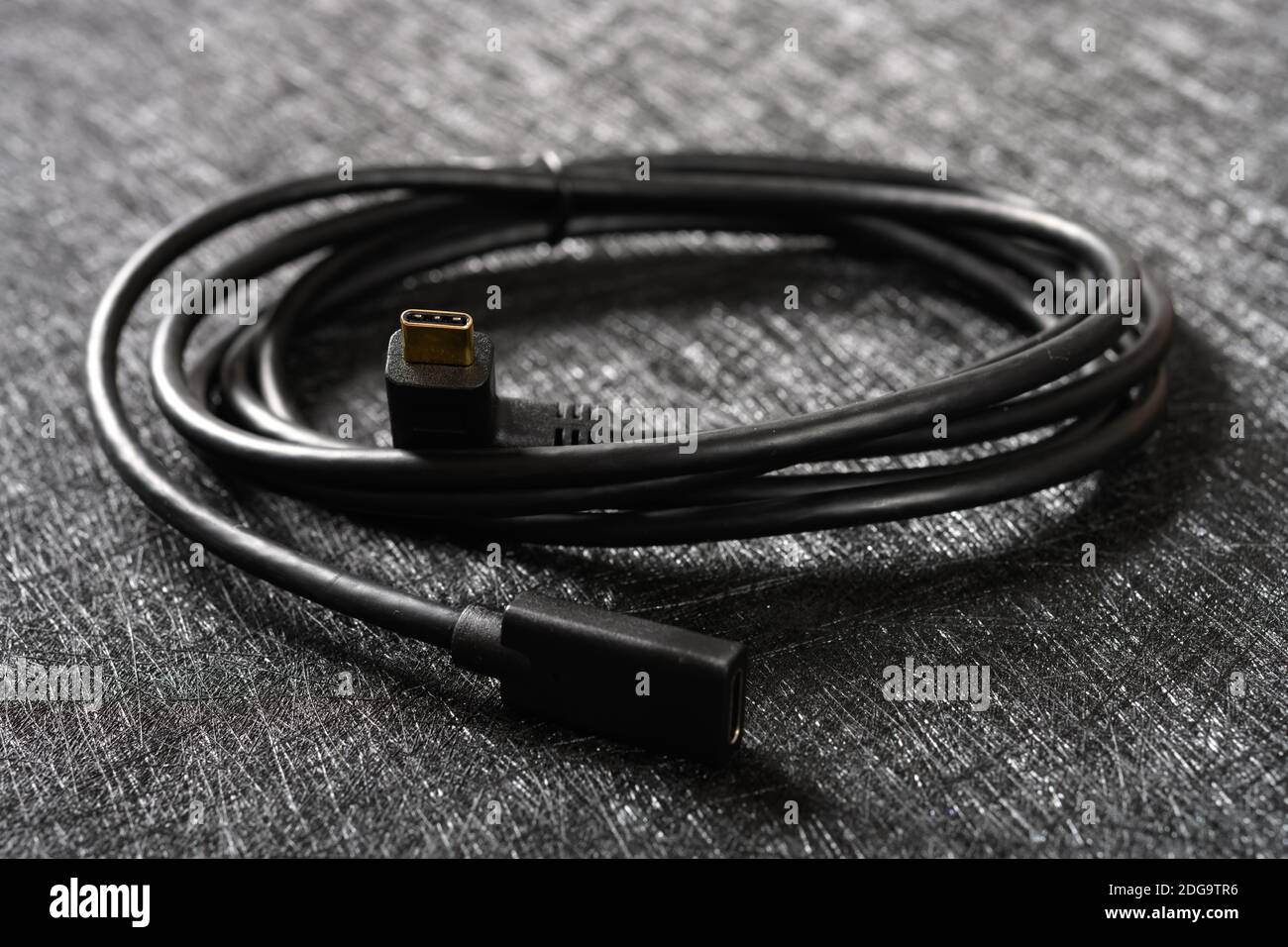 type C cable with male plug and female socket on a dark background ...