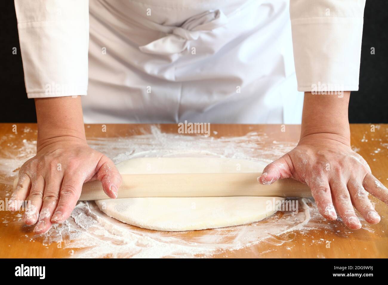 how to make japanese udon noodles; use a rolling pin to roll the dough ...