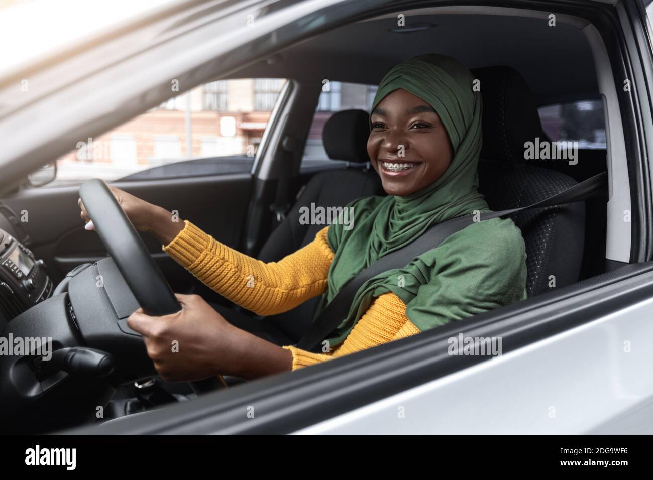 Road Trip. Black Muslim Woman In Hijab Enjoying Driver Car In City ...