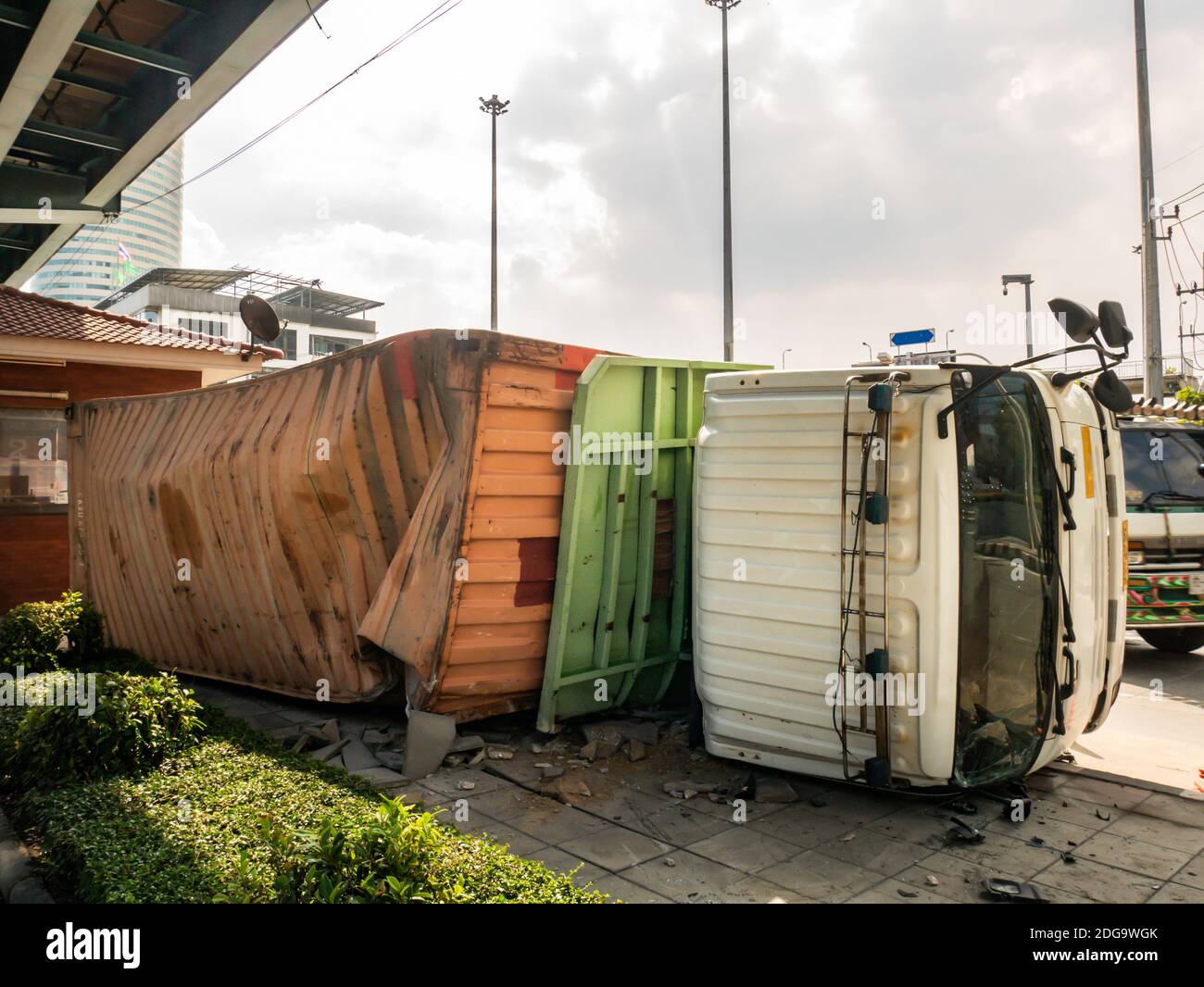 A truck carrying a container overturned on a road under a bridge over ...