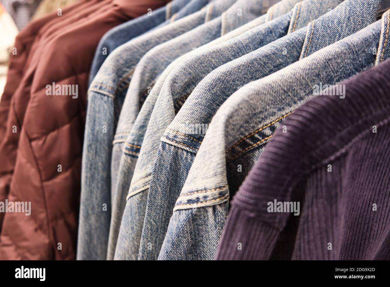 Different casual men shirts hang on hanger racks at store Stock Photo ...