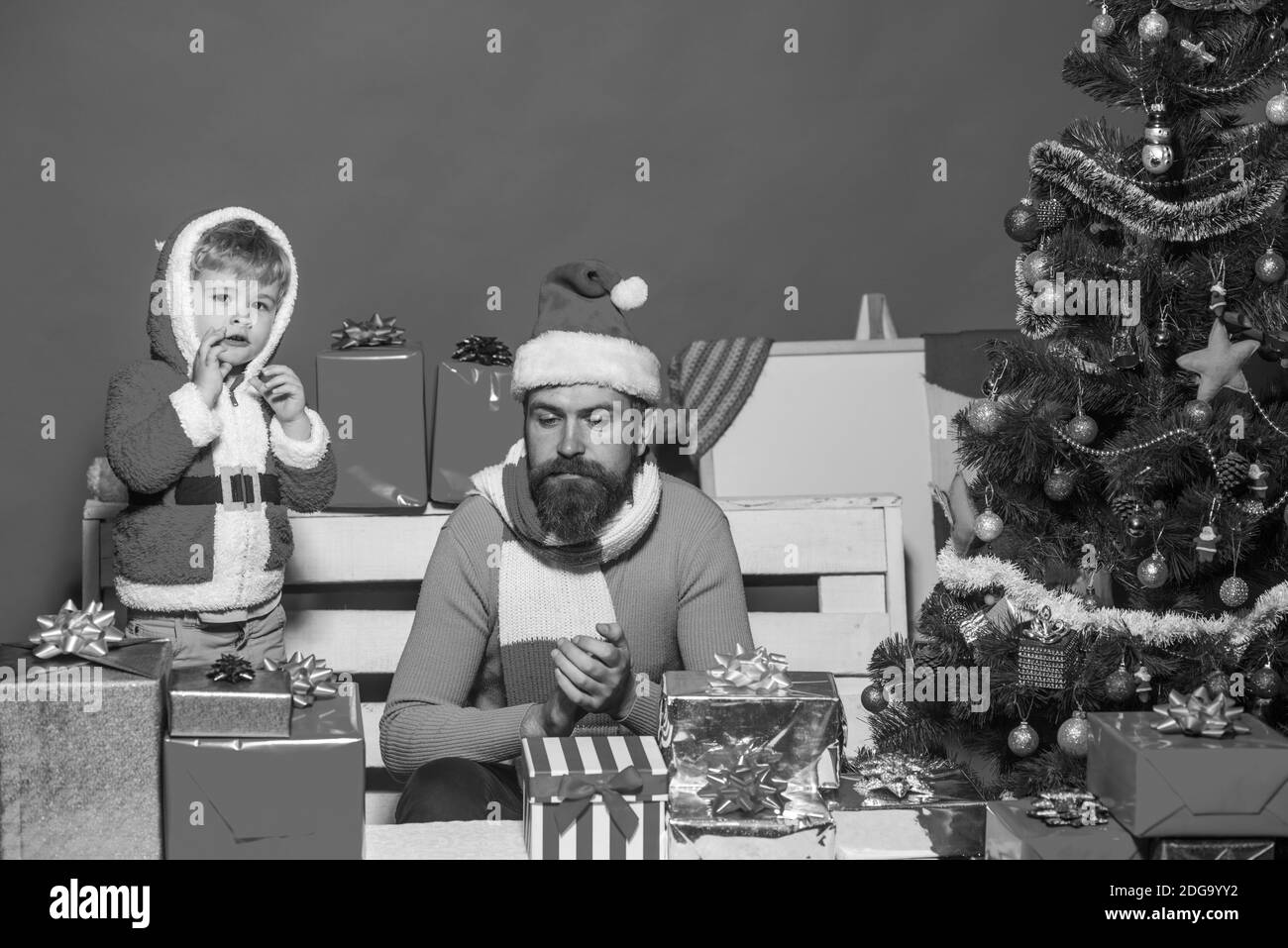Christmas family opens presents on dark red background. Santa and ...