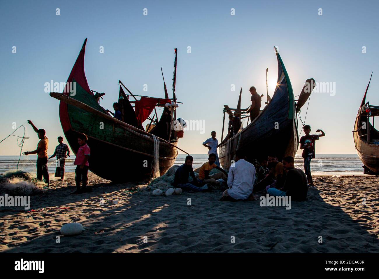 Fishermen prepares the fishing nets ahead of the next high tide. The ...