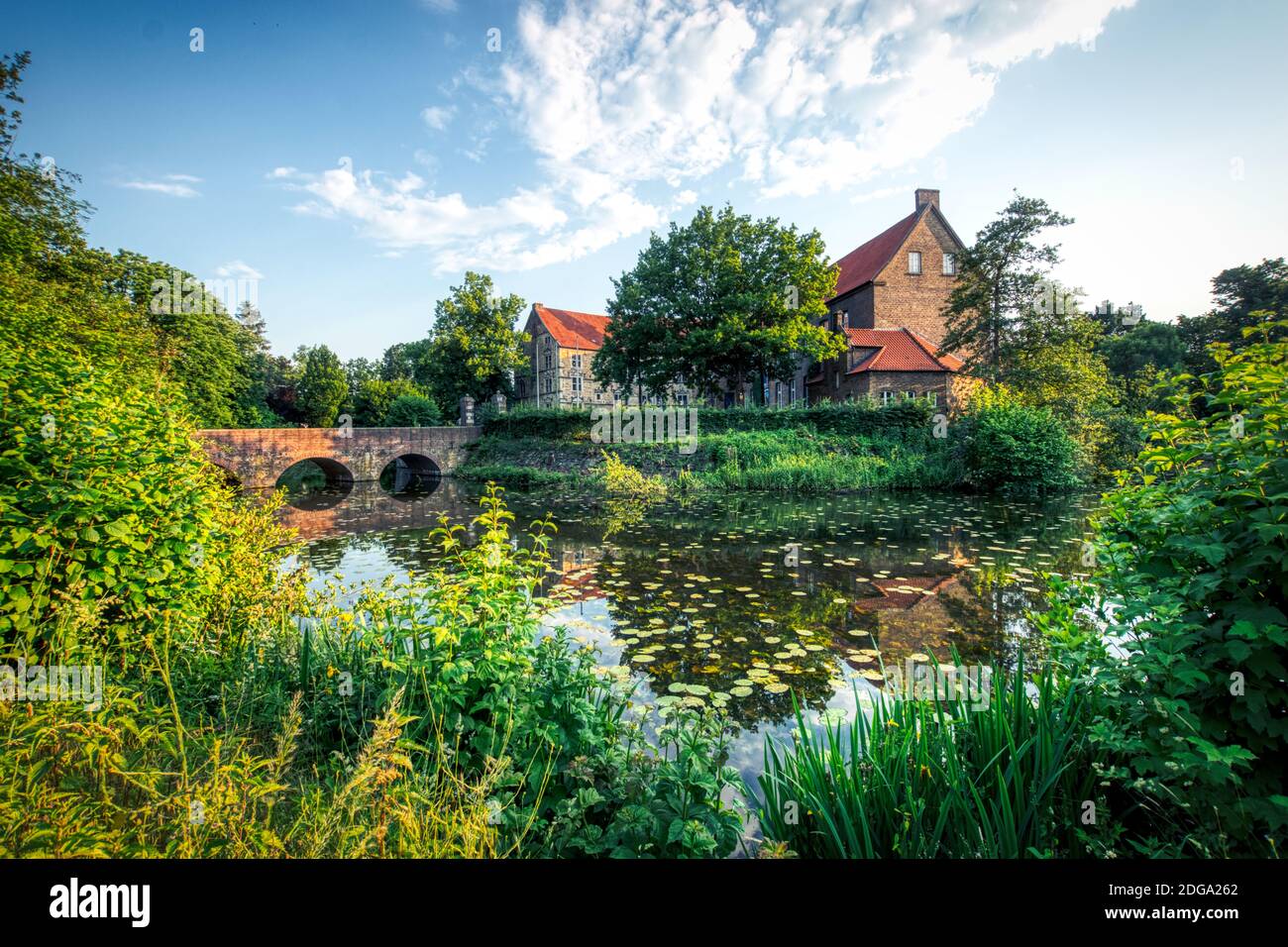 A view of an old building and bridge in the greenery landscape of ...
