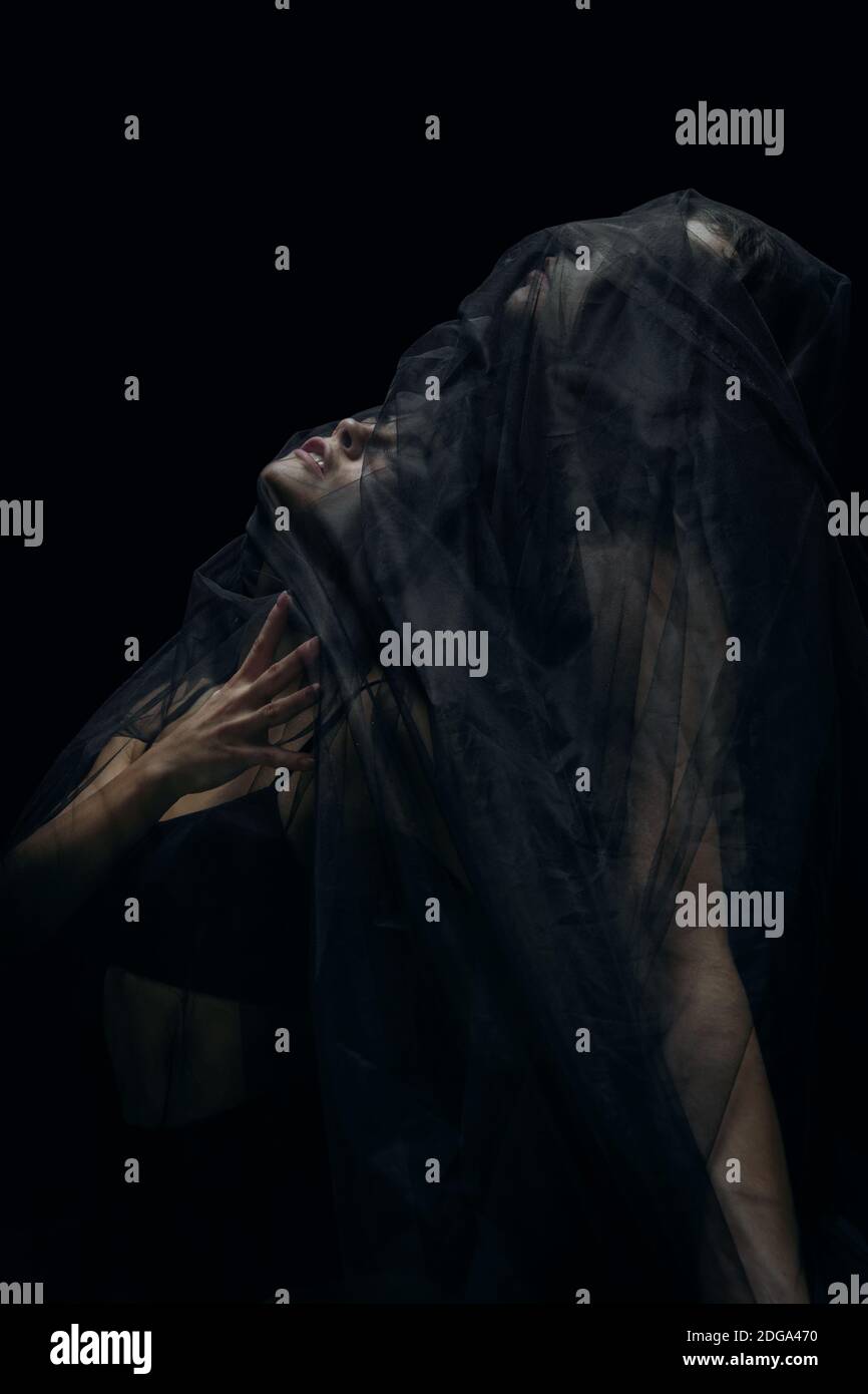 Mystery. Graceful classic ballet dancers isolated on black studio ...