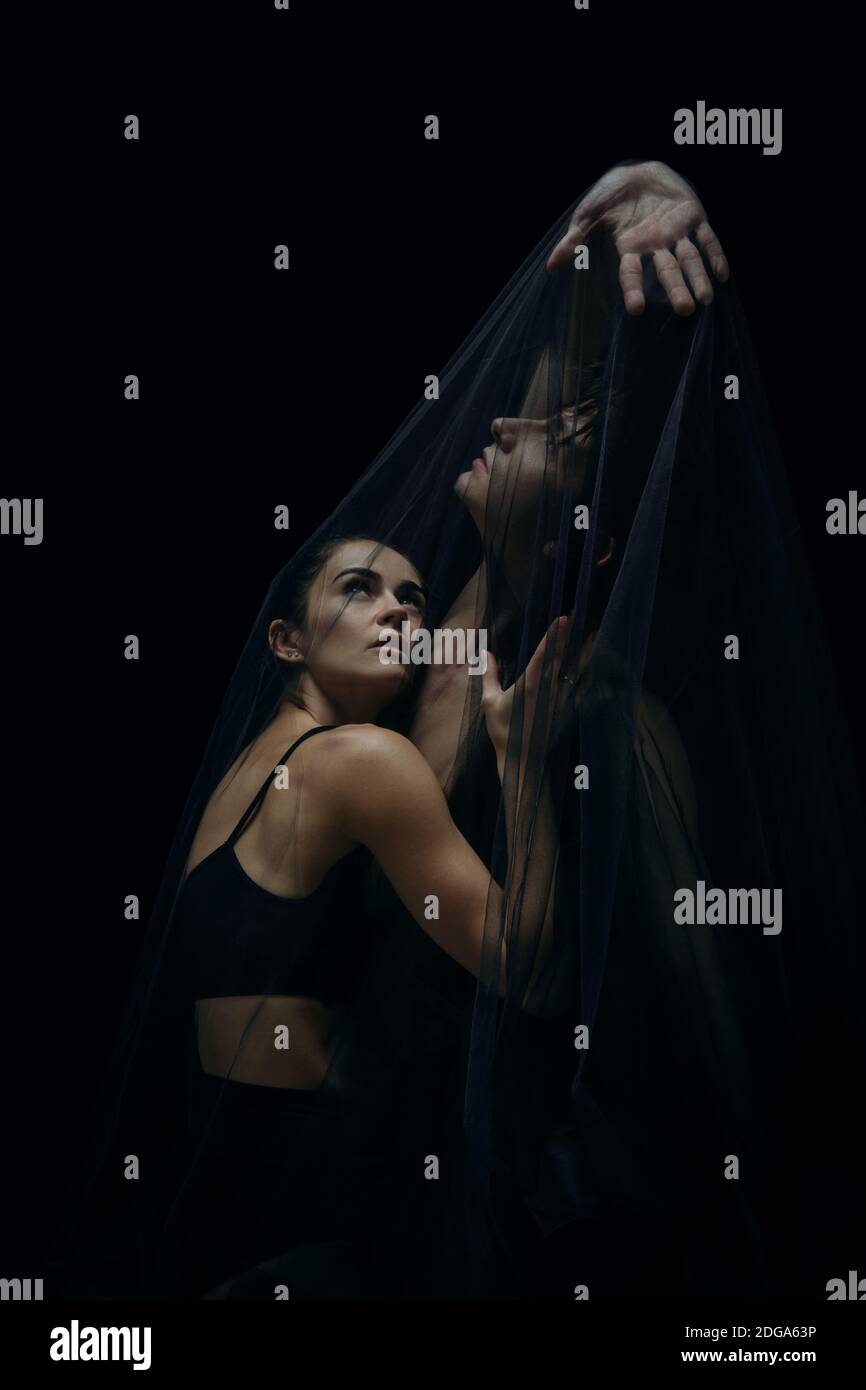 Skin. Graceful classic ballet dancers isolated on black studio ...