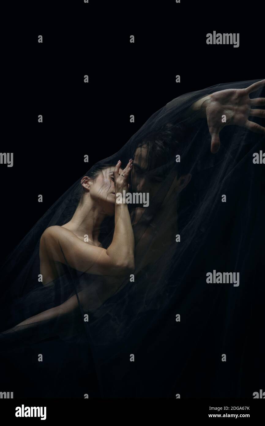 Body warm. Graceful classic ballet dancers isolated on black studio ...