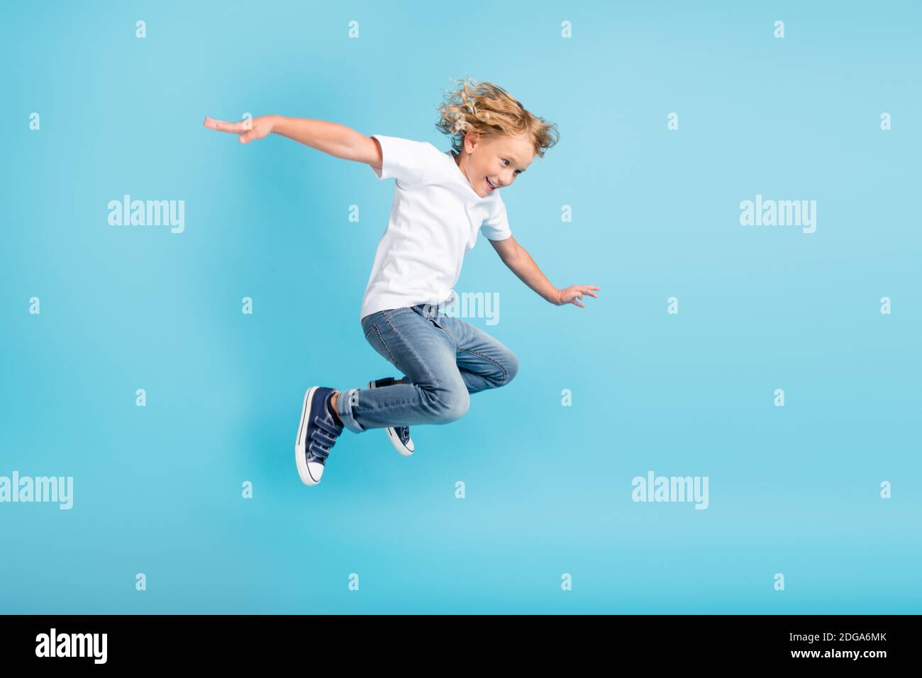 Profile photo of young boy jump fly movement hands wear white shirt ...