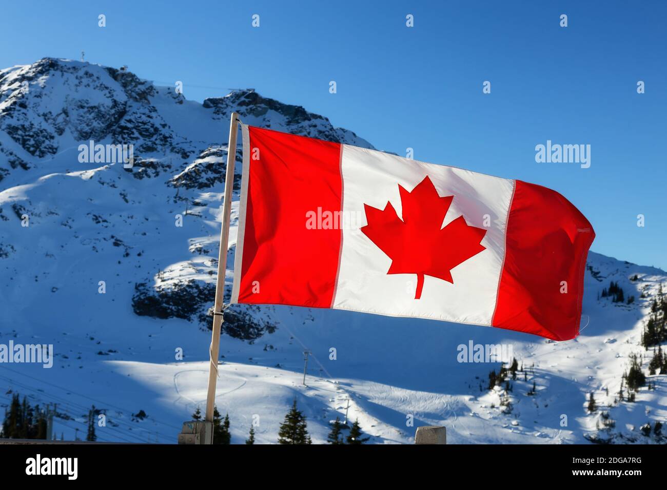 Canadian Flag with a winter mountain landscape Stock Photo - Alamy