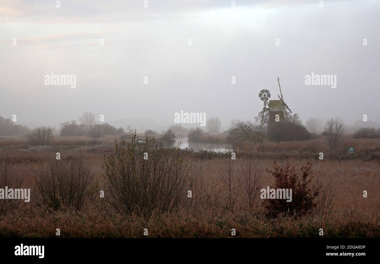 An atmospheric landscape on the Norfolk Broads by the River Ant on a ...