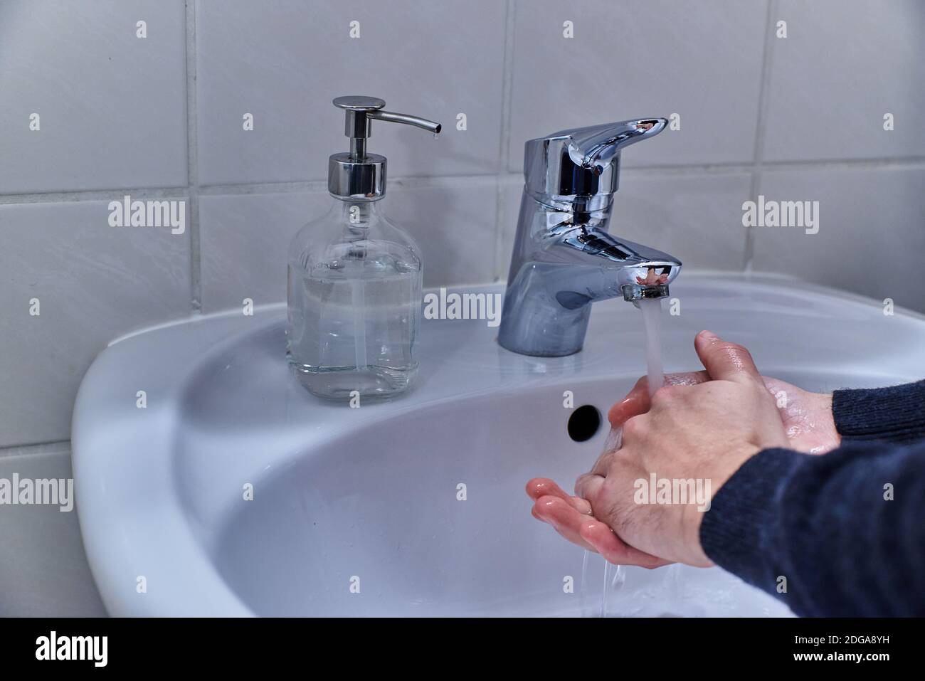 Close up of a person washing hands. Person washing their hands with ...