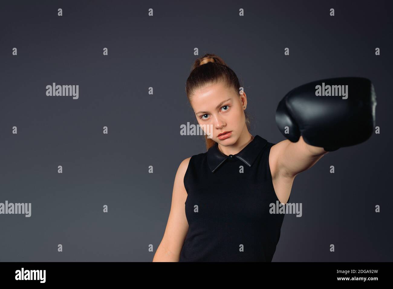 Young business lady celebrates victory with boxing gloves. Business and ...