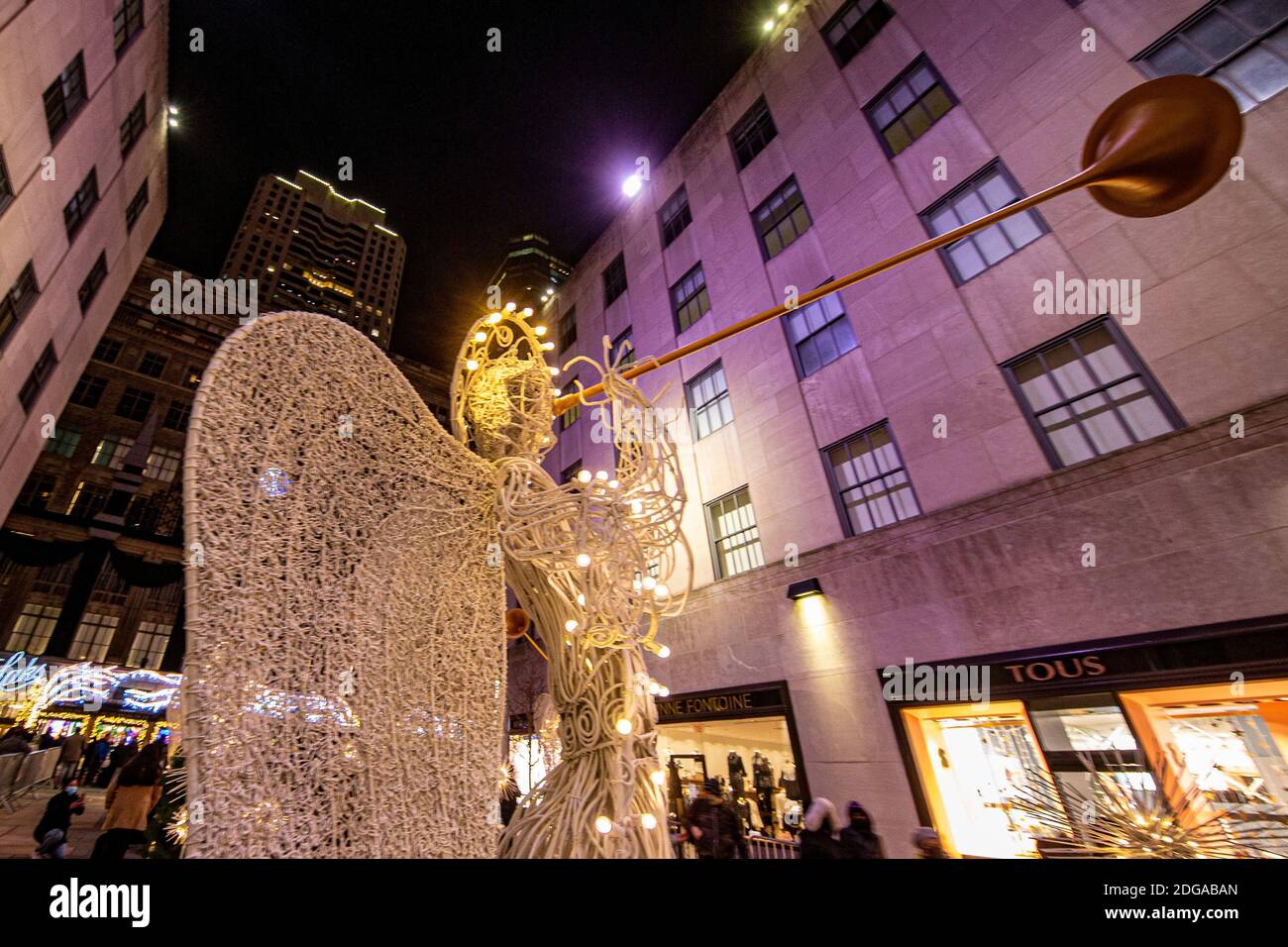 Angels hold up trumpets in the garden at Rockefeller Center. (Photo ...