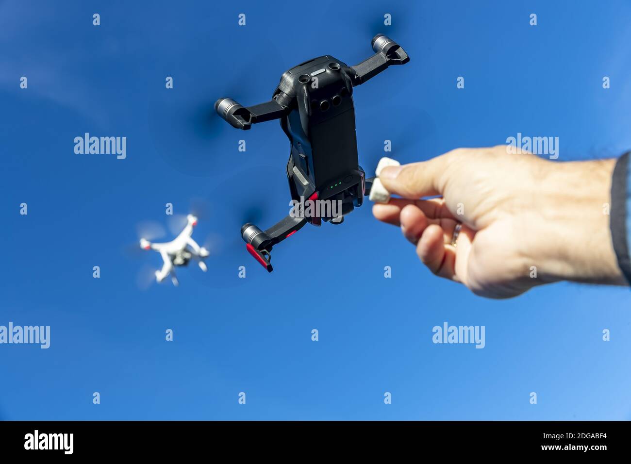 A Group Of Drones Fly Together Through The Air Against A Blue Sky Stock ...