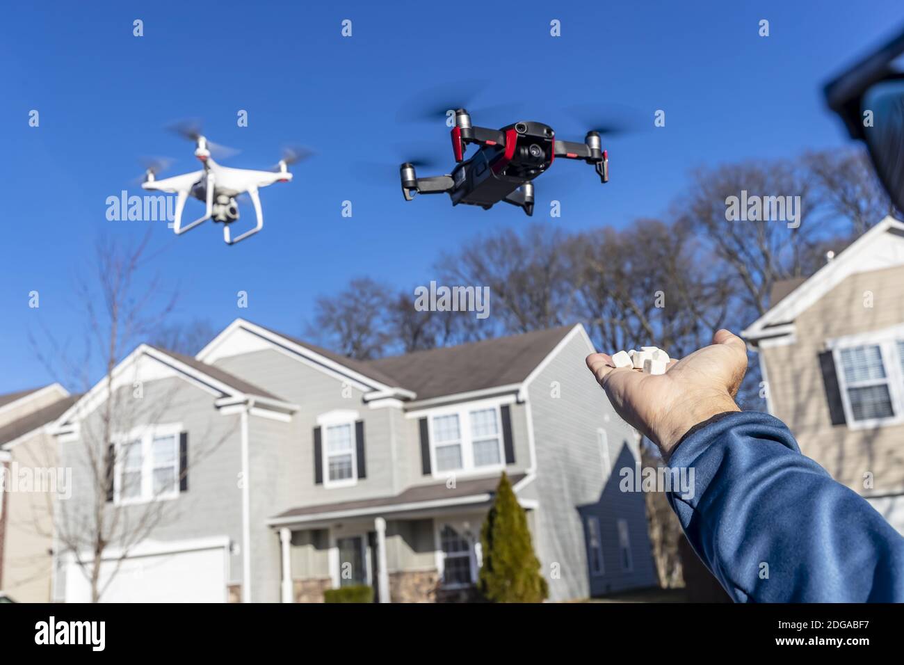 A Group Of Drones Fly Together Through The Air Against A Blue Sky Stock ...