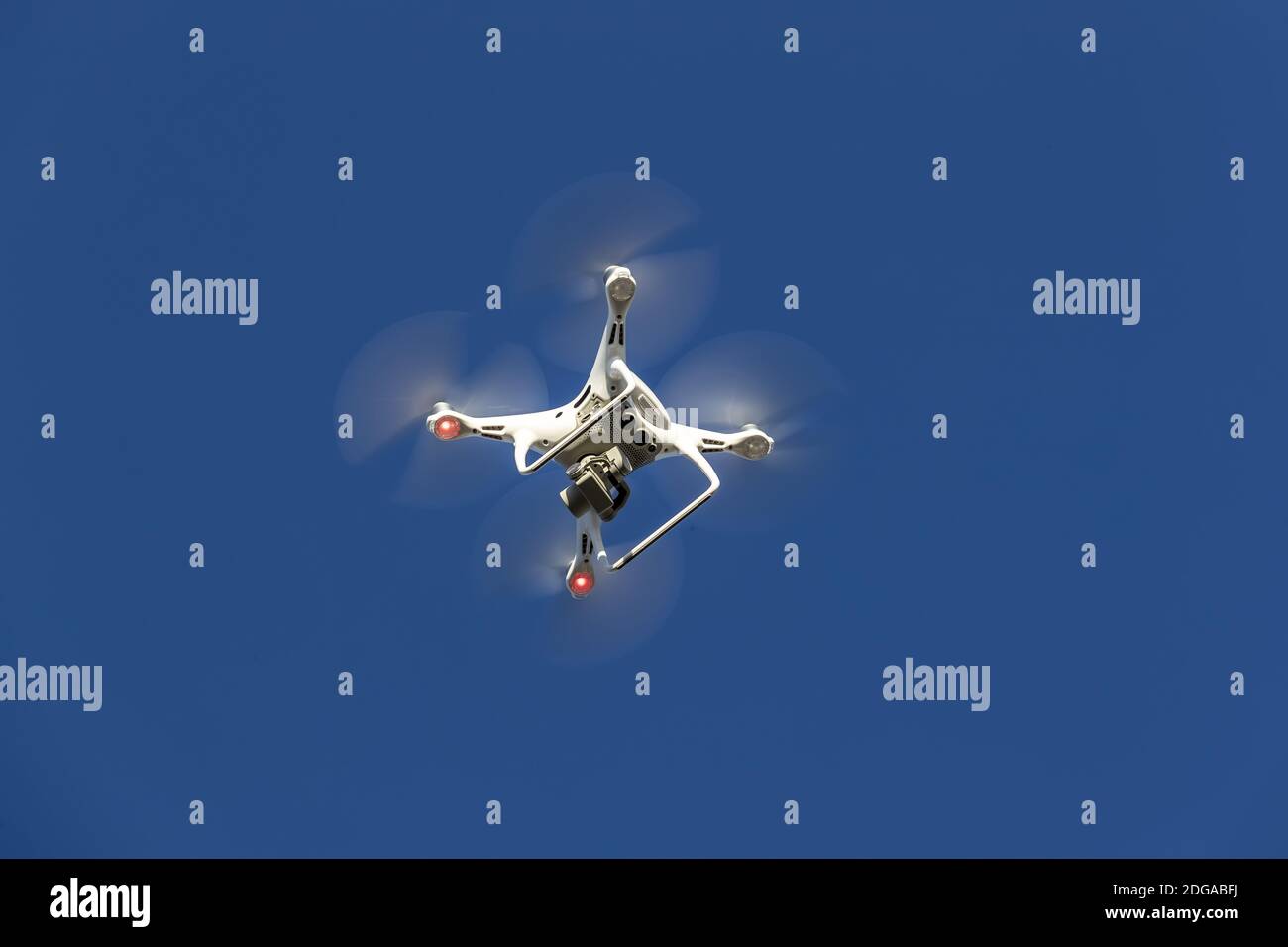 A Group Of Drones Fly Together Through The Air Against A Blue Sky Stock ...