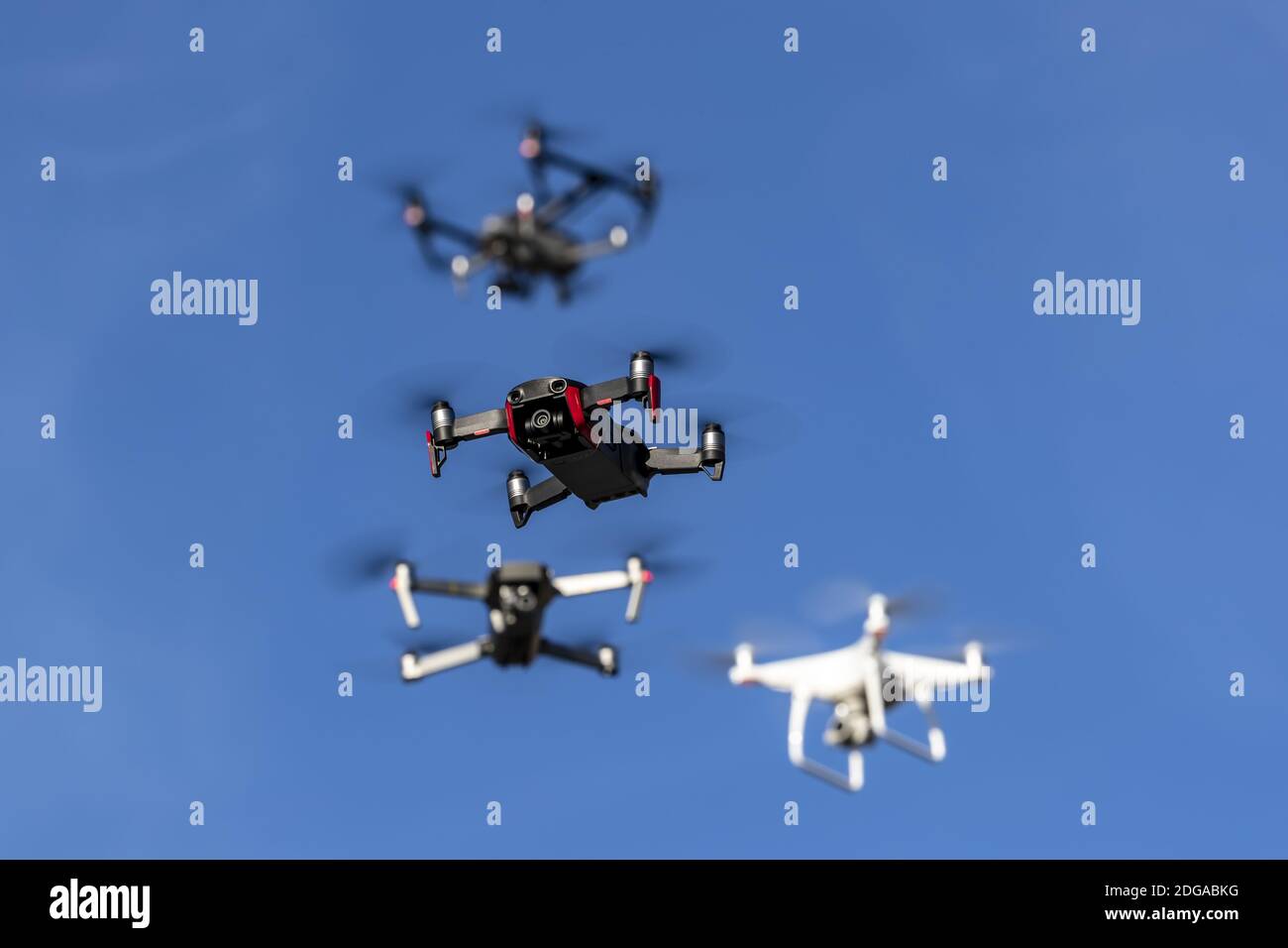 A Group Of Drones Fly Together Through The Air Against A Blue Sky Stock ...