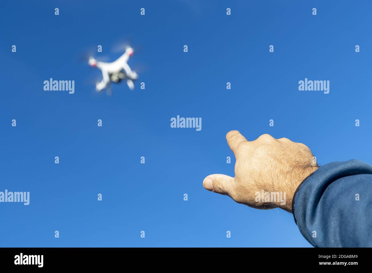 A Group Of Drones Fly Together Through The Air Against A Blue Sky Stock ...