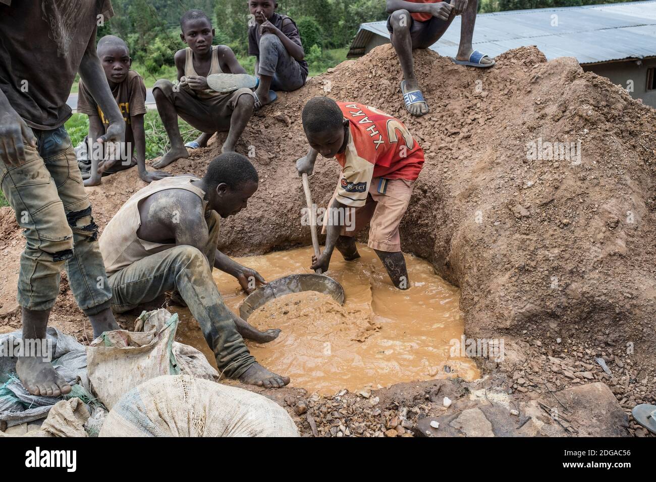 Child labour inside an artisanal illegal mining in Uganda Stock Photo ...