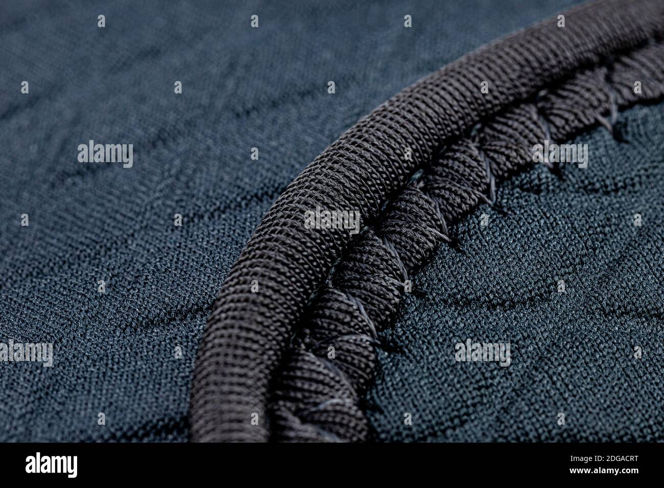Macro background made of a seam on a fabric in navy blue color ...
