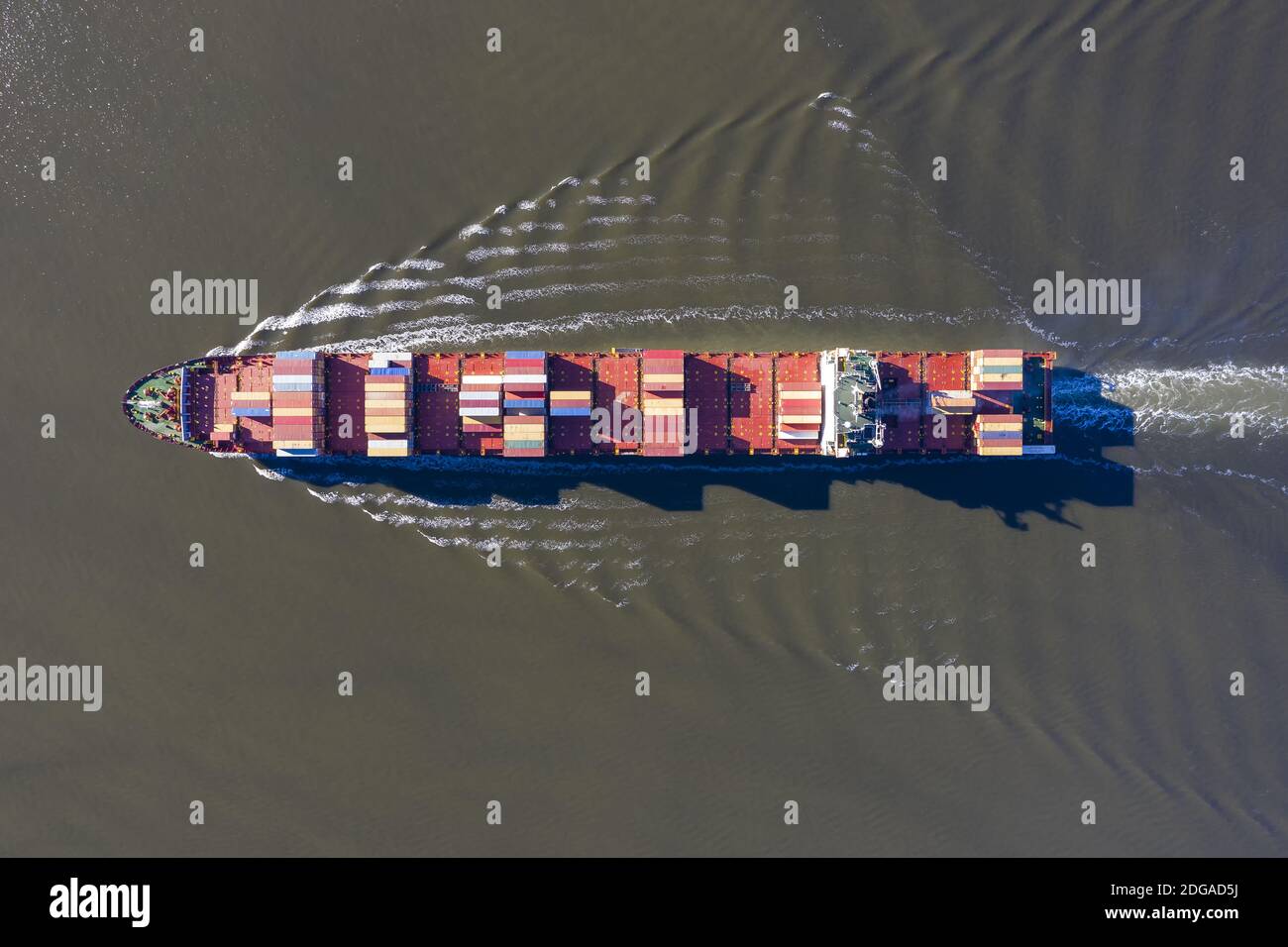 A Cargo Ship Steams Towards The Open Ocean Out Of A Harbor Stock Photo ...