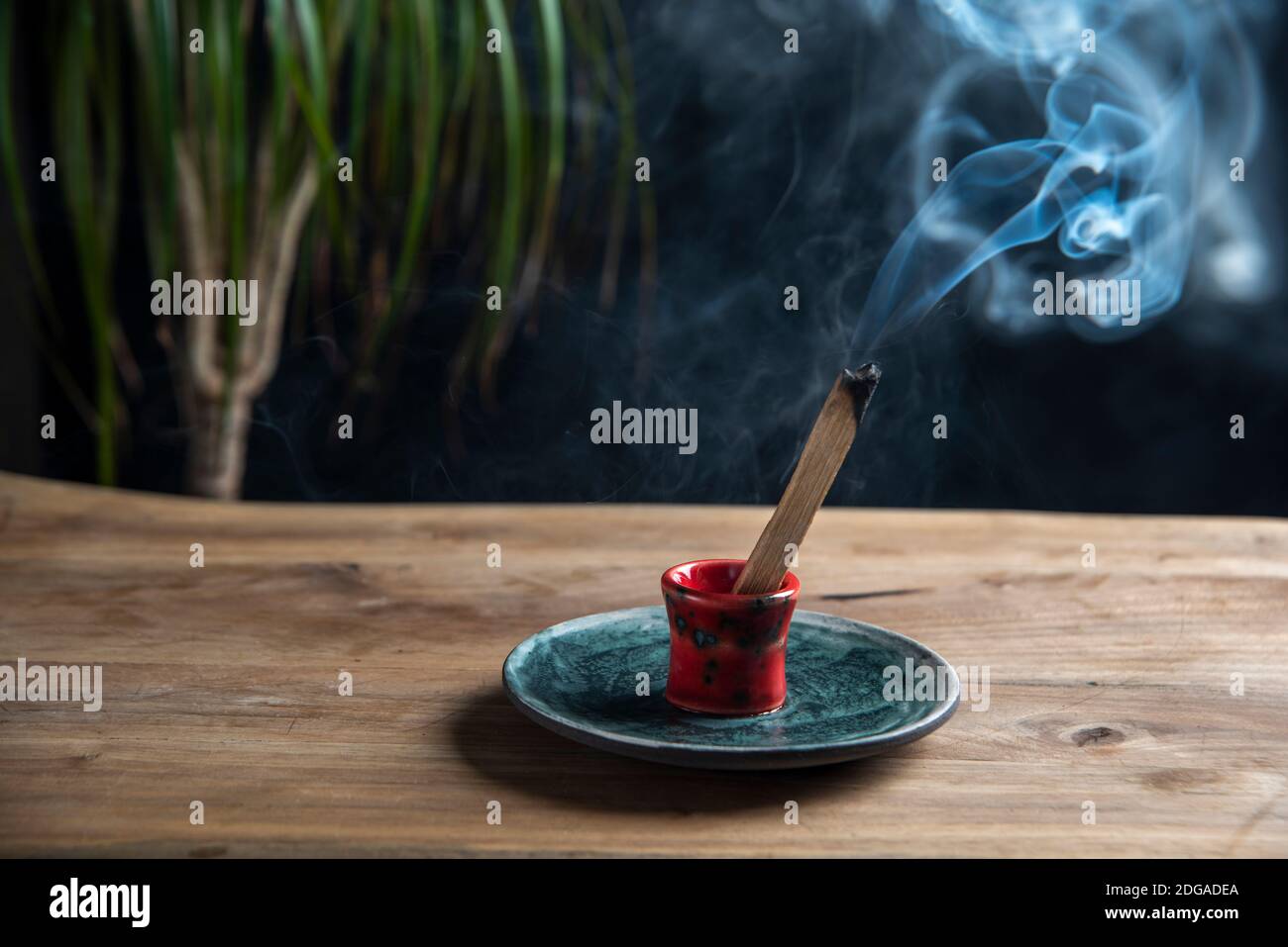 incense with ceramic plate on wooden table Stock Photo - Alamy