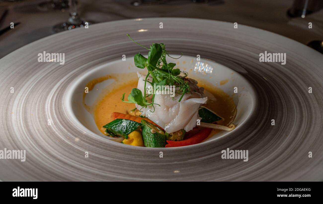 Fish dish with vegetable and salads. Monkfish medallions Stock Photo ...