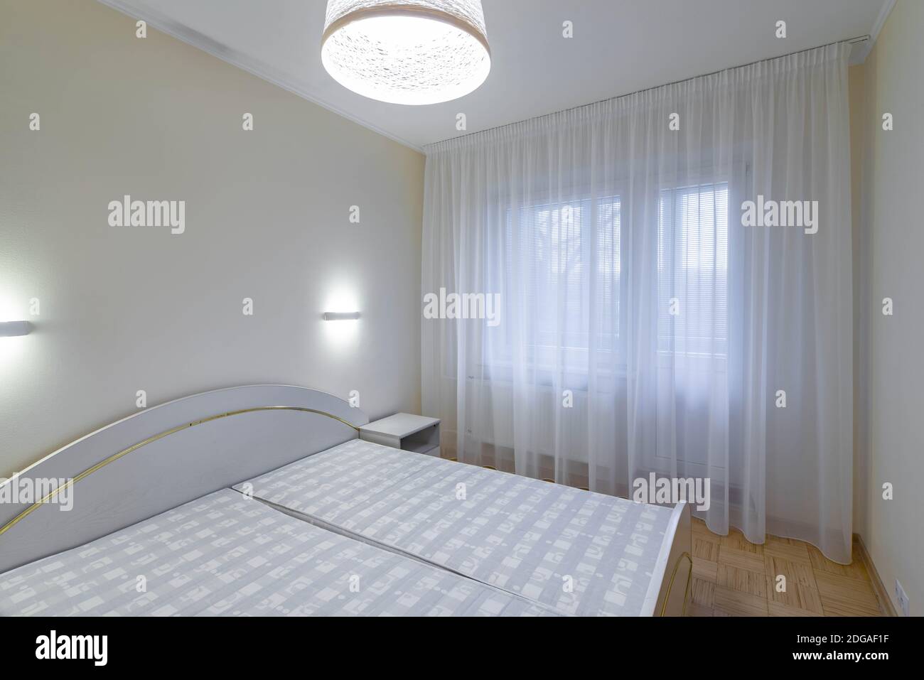 Modern interior of bedroom in light tones. Cozy bed. White walls ...