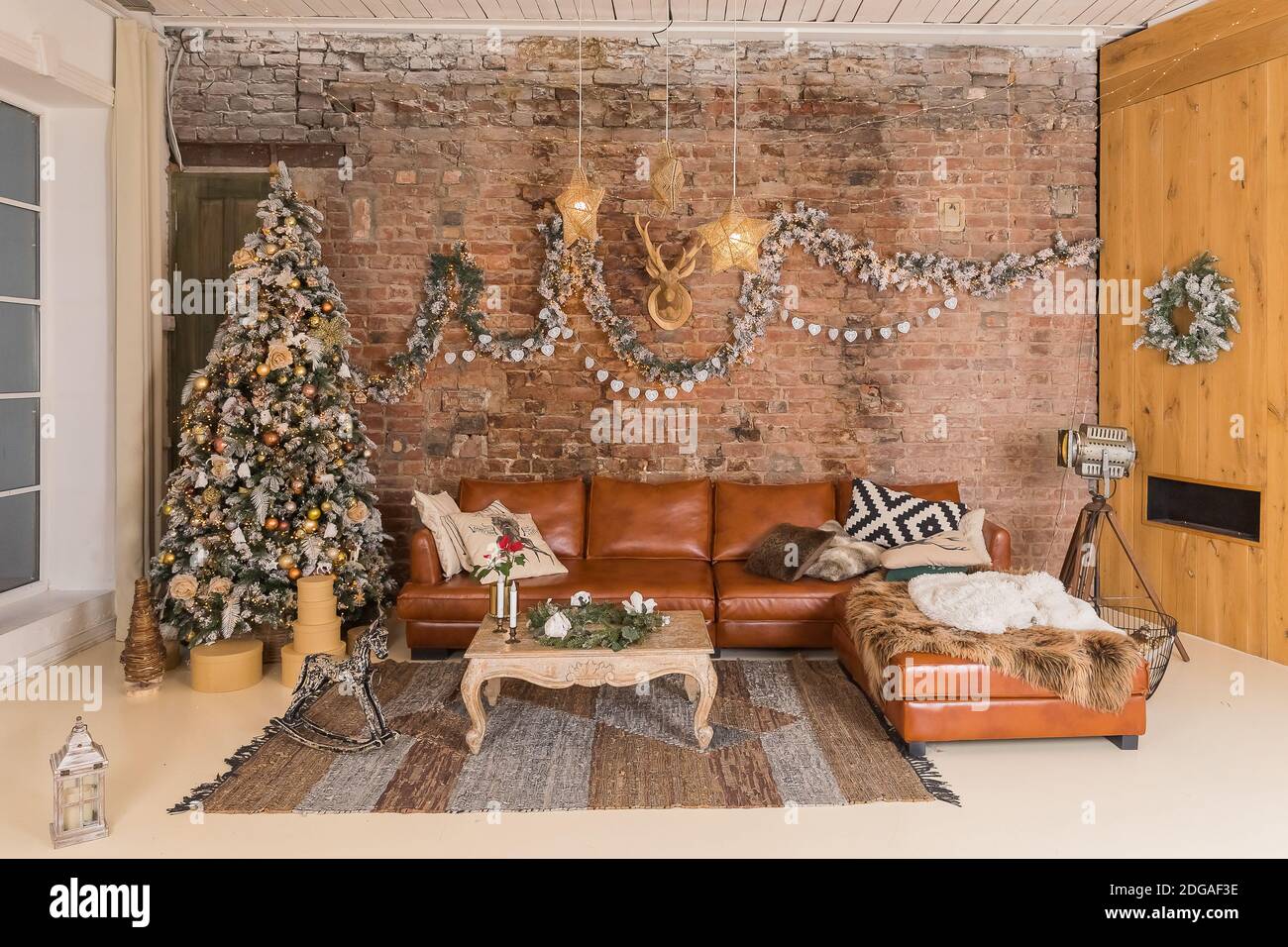 Winter home decor. Christmas tree in loft interior against brick wall ...